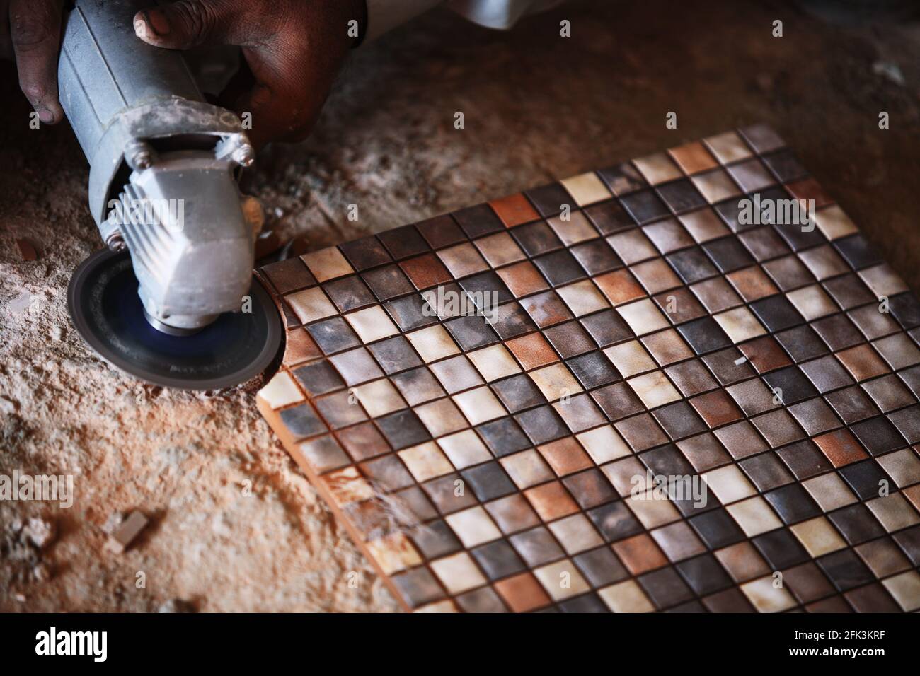 Tile mason is cutting ceramics tile with electric grinder Stock Photo ...