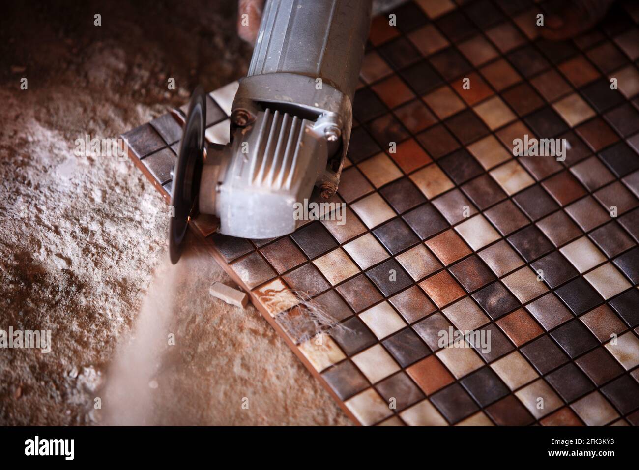 Tile mason is cutting ceramics tile with electric grinder Stock Photo ...