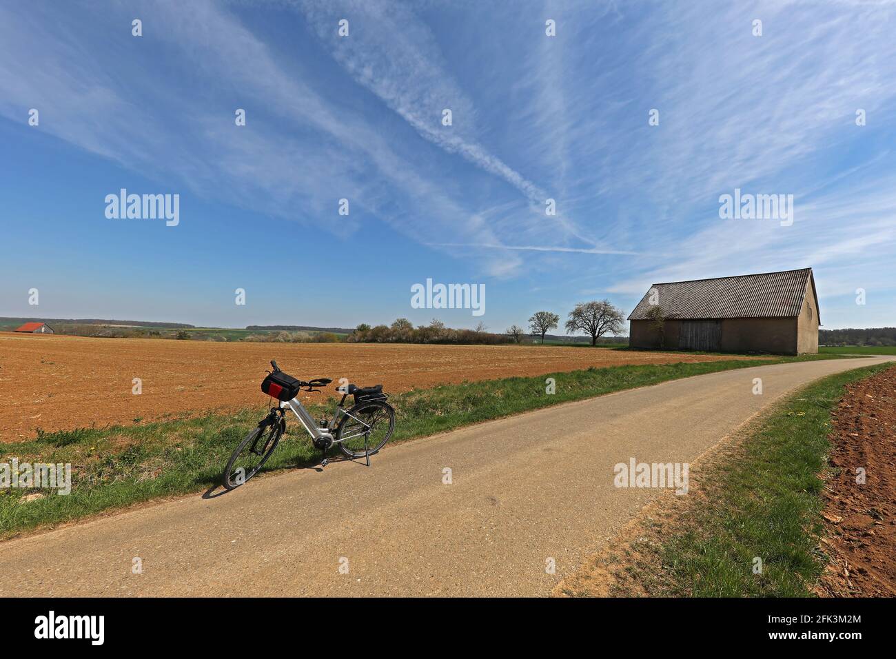 Spring landscape with an e-bike on the way Stock Photo - Alamy