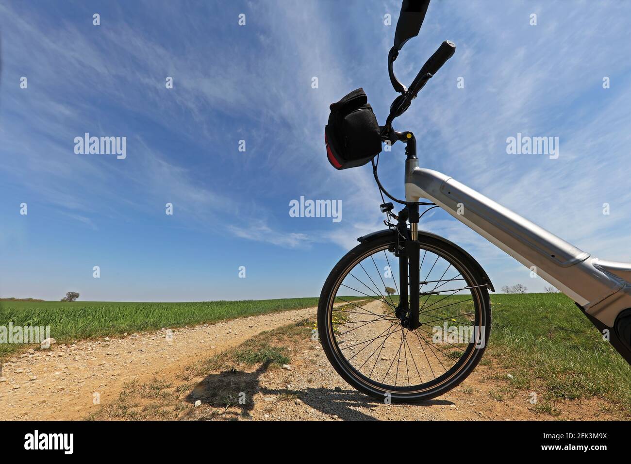 Spring landscape with an e-bike on the way Stock Photo - Alamy