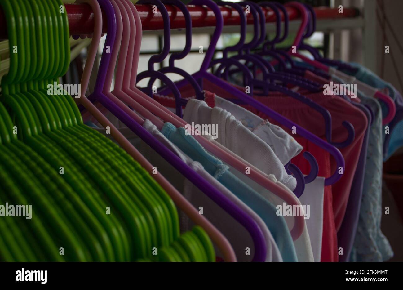 Closeup of a rack with hanged clothes Stock Photo - Alamy