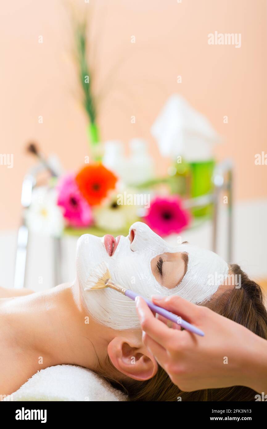 Wellness - woman receiving nurturing facial mask in spa for moist and ...