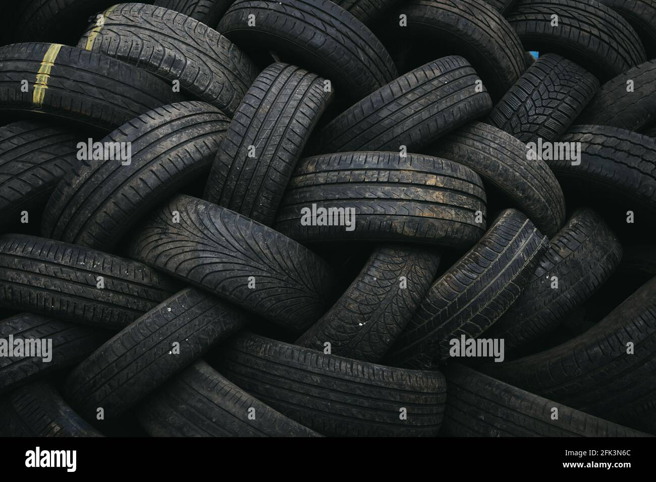 Full frame close up of tyres from scrapped cars in vehicle recycling ...