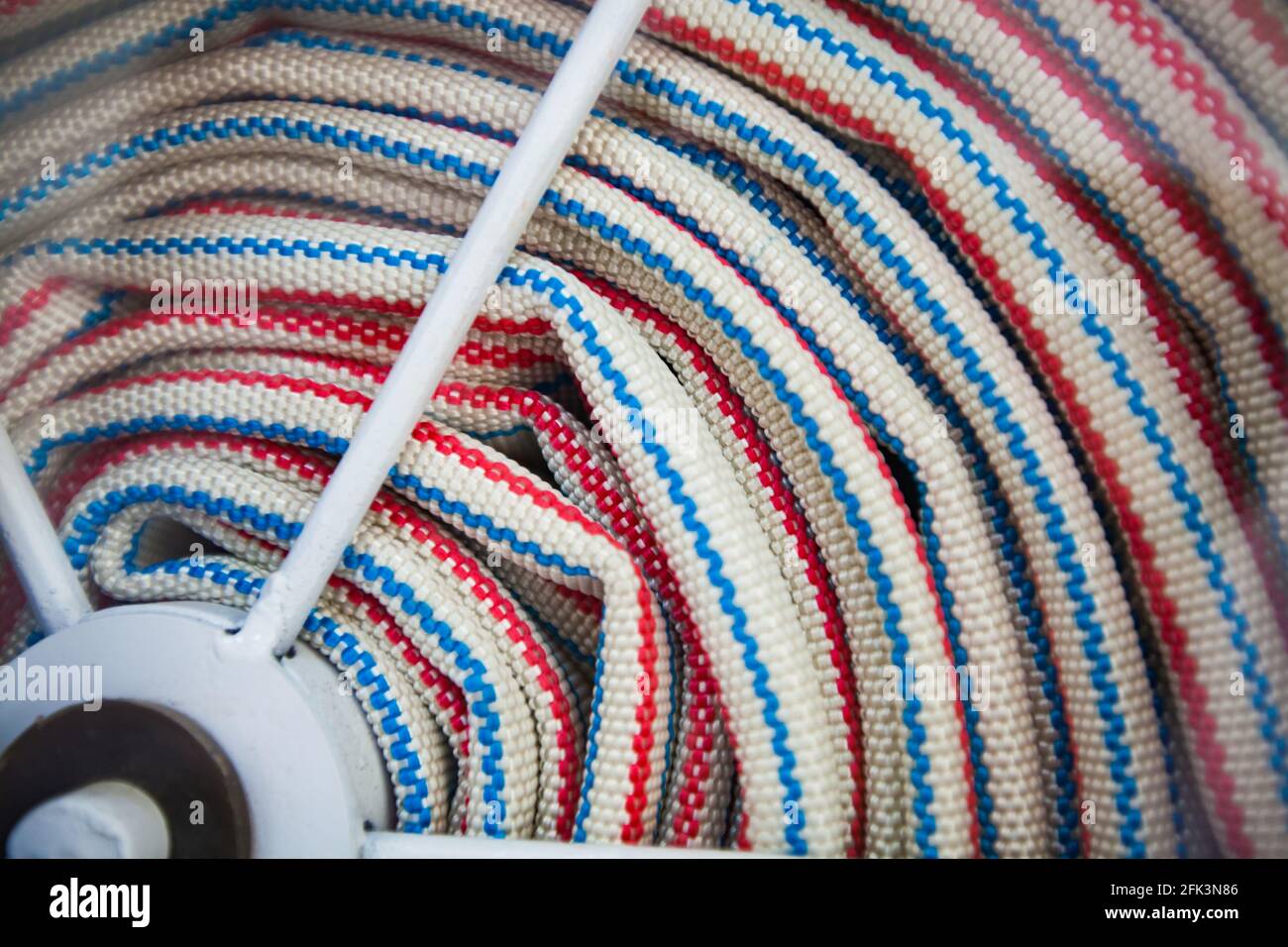 Abstact industrial background. Closeup photo of fire hose on bobbin ...