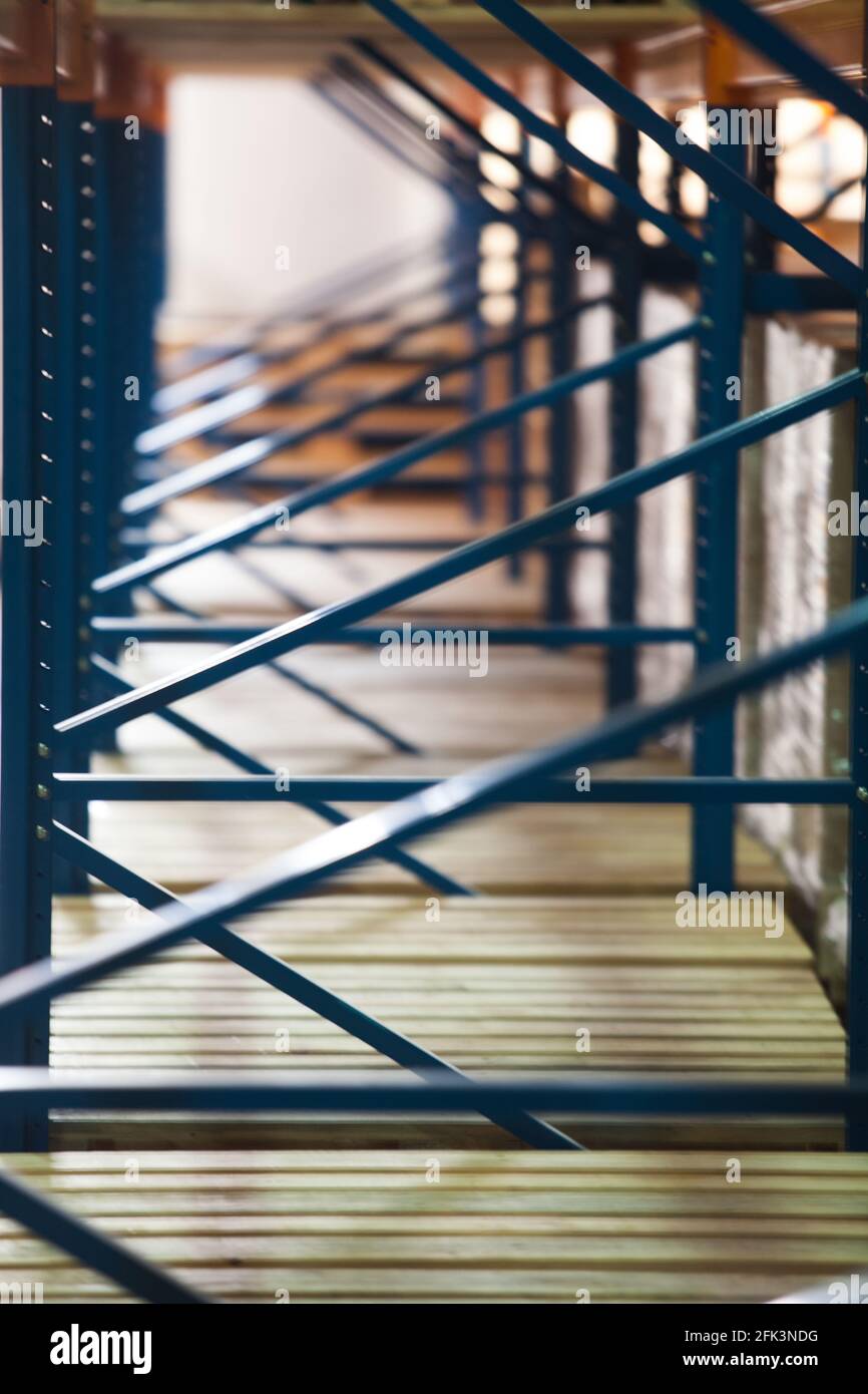 Blue painted steel storage racking system. Abstract industrial ...