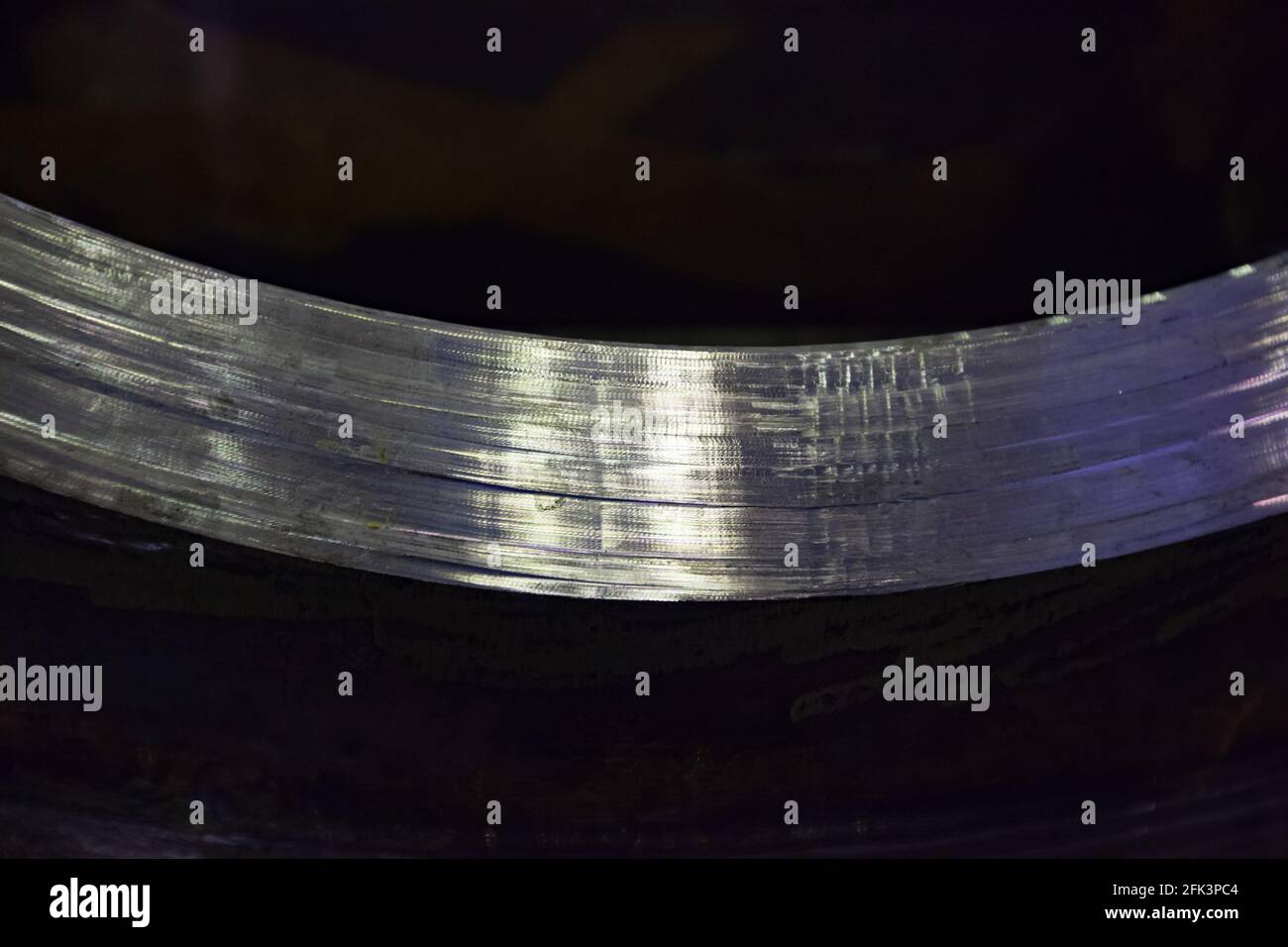 Steel ingot after turning lathe machining. Close-up of scratches, black ...