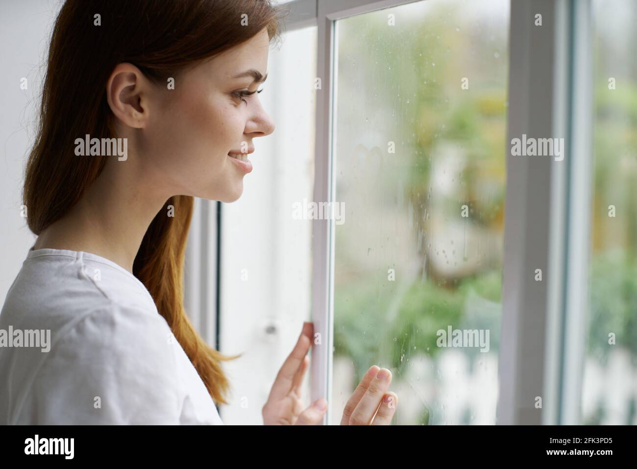 happy woman looking out the window at nature side view Stock Photo - Alamy