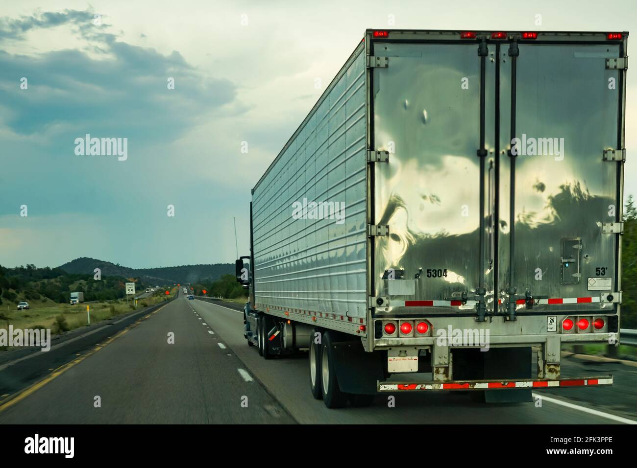 Huge truck with highly polished back doors that reflect the ...