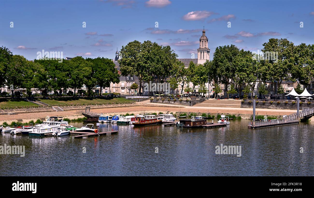 Barges on the Maine river at Angers and the La Trinité church among the ...