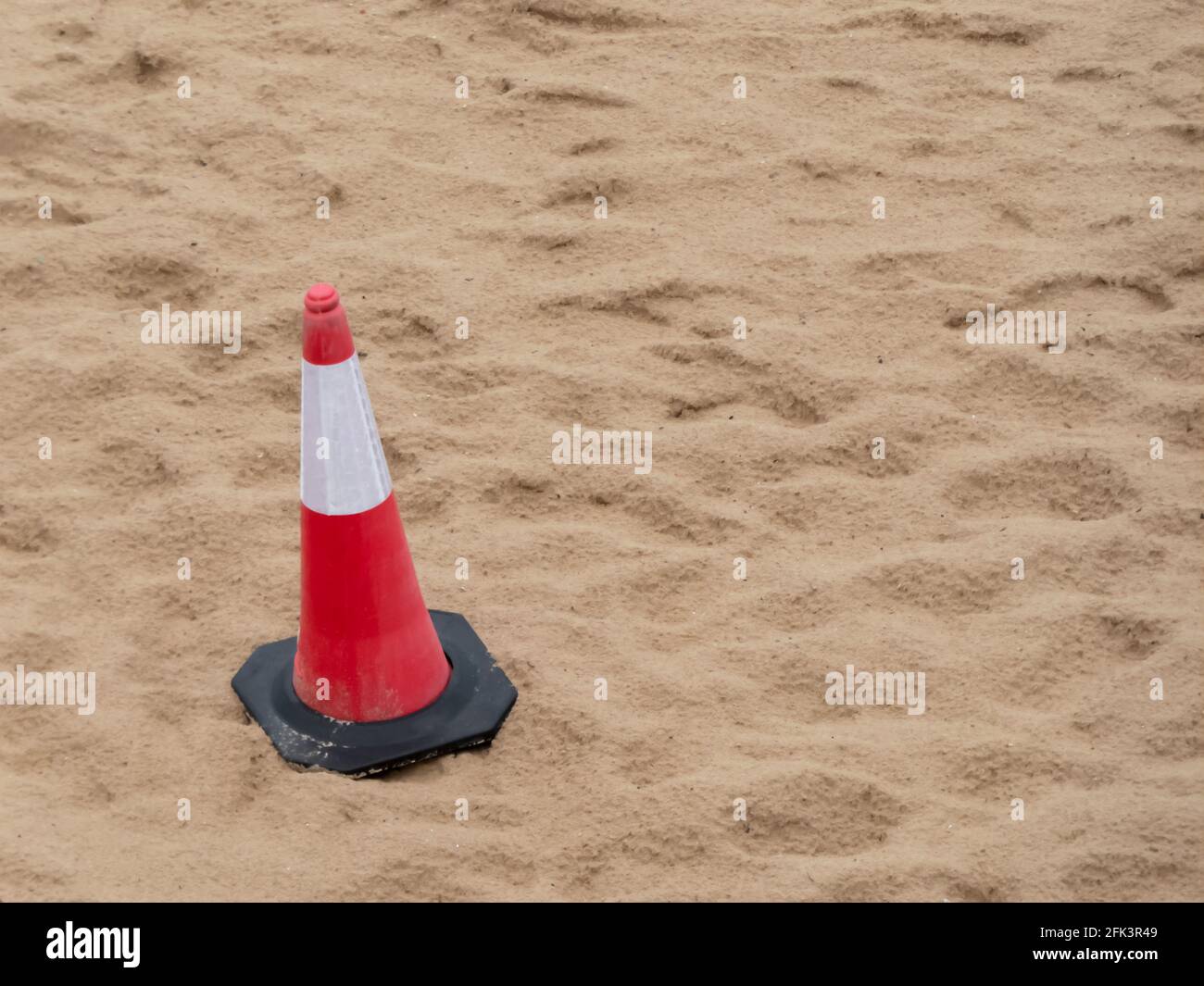 Close-up of warning cone on the sand of a beach Stock Photo - Alamy