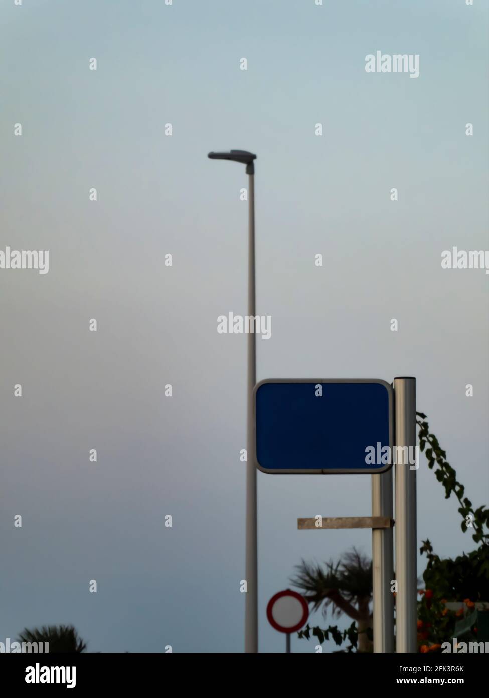 Blank information sign under a cloudy sky at sunset Stock Photo - Alamy