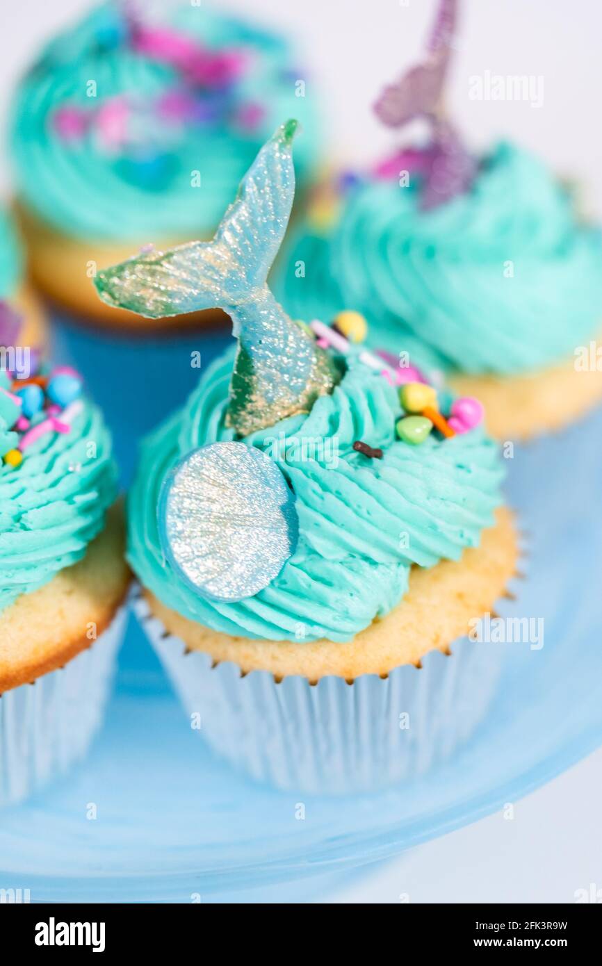 Gourmet mermaid cupcakes topped with blue buttercream frosting and ...