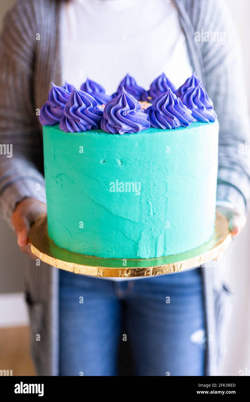 Birthday cake with turquoise buttercream and purple rosettes and ...