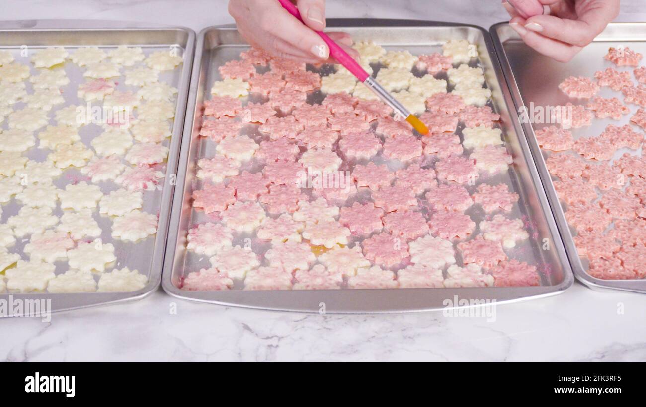 Step by step. Dusting chocolate snowflakes with glittery food dust ...