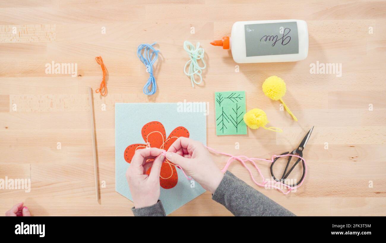 Mother teaching kids how to sew with simple sewing kit at the craft ...