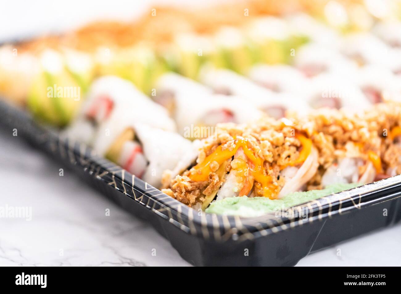 Pre-packaged variety of sushi and sushi rolls in a plastic tray Stock ...