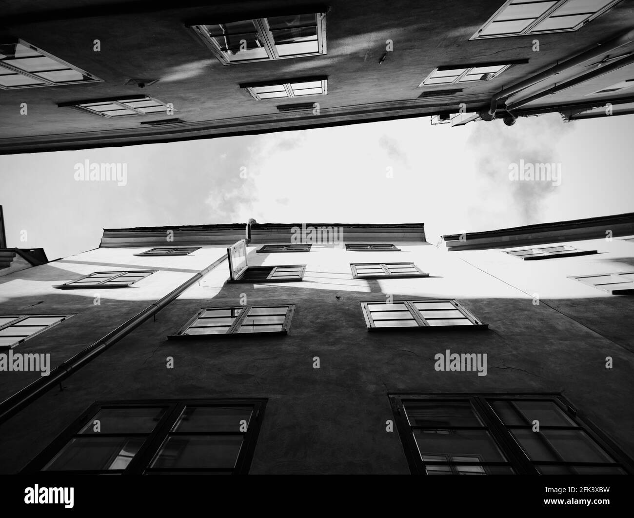 Narrow space between two tall buildings Stock Photo - Alamy