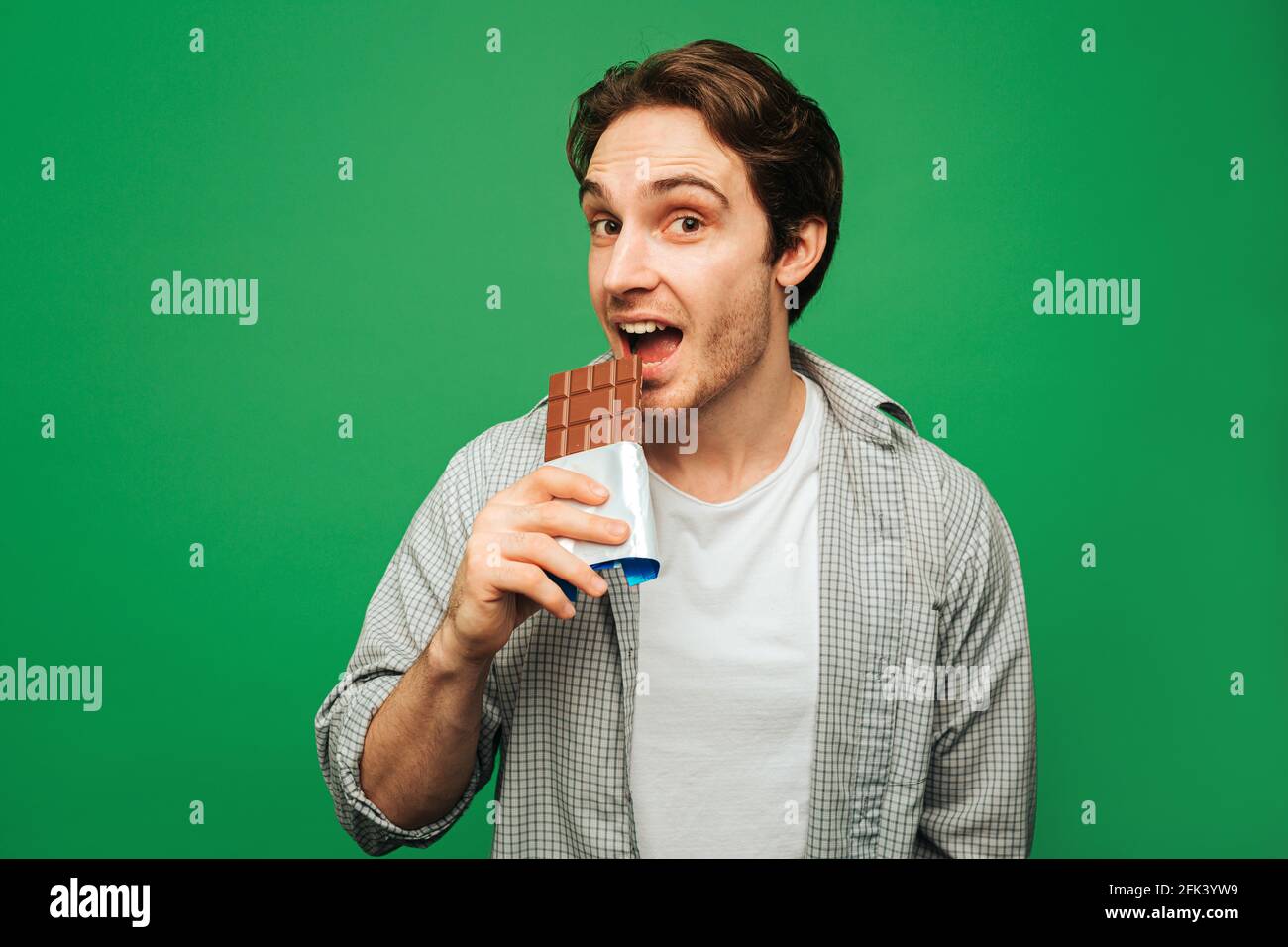 Man eating chocolate bar and happy hi-res stock photography and images ...