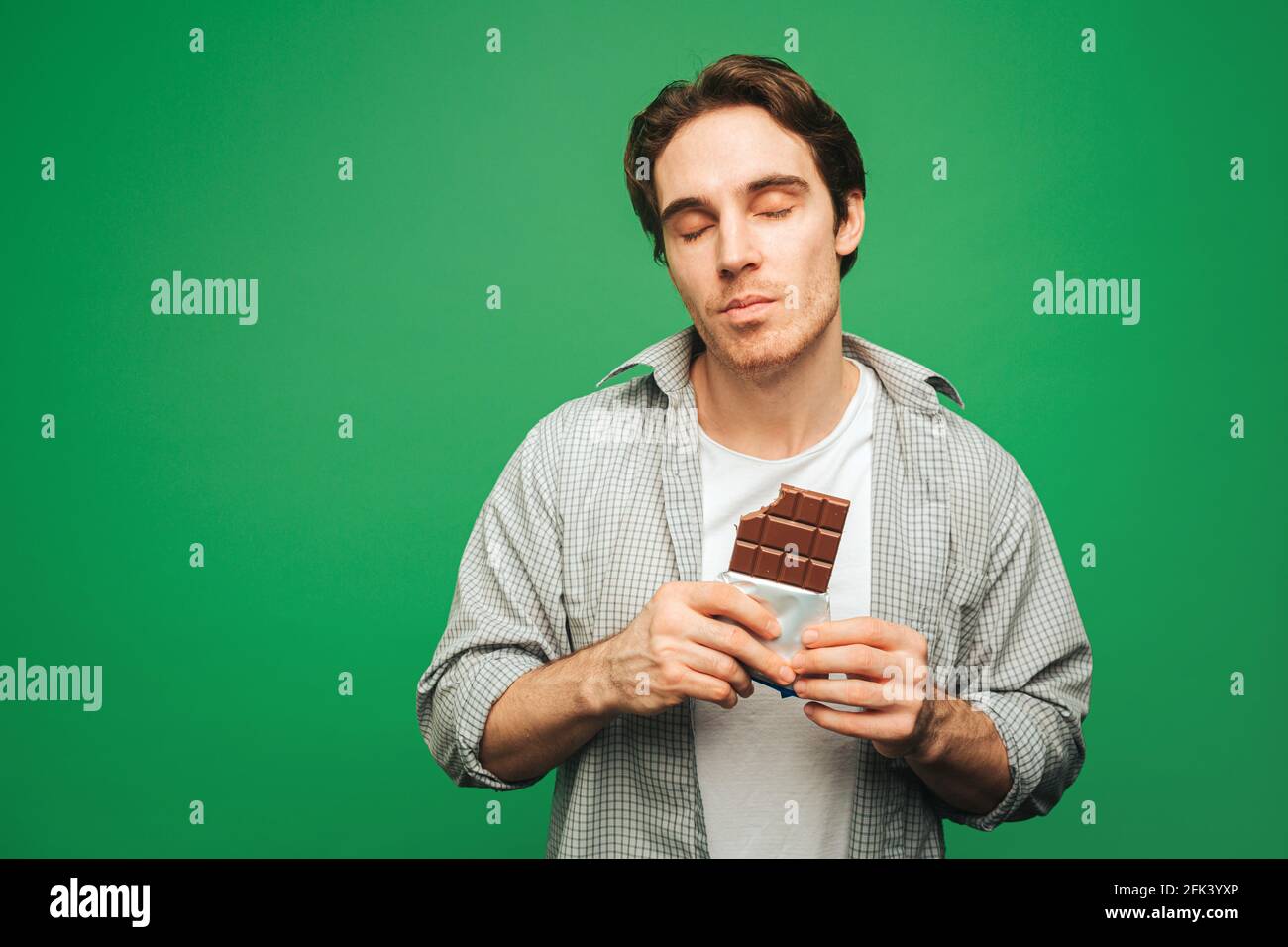 Man eating chocolate bar and happy hi-res stock photography and images ...