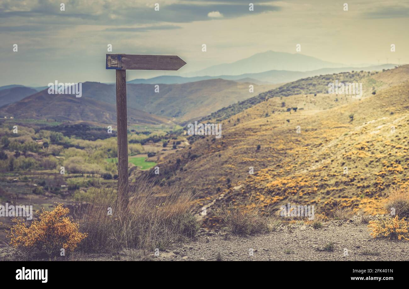 Wooden signpost with an arrow, for mountain routes or visitation areas ...