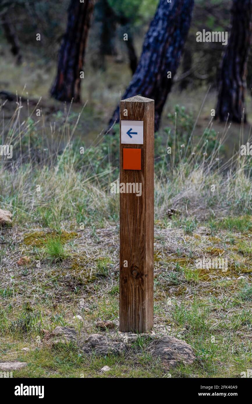 Wooden signpost with an arrow, for mountain routes or visitation areas ...