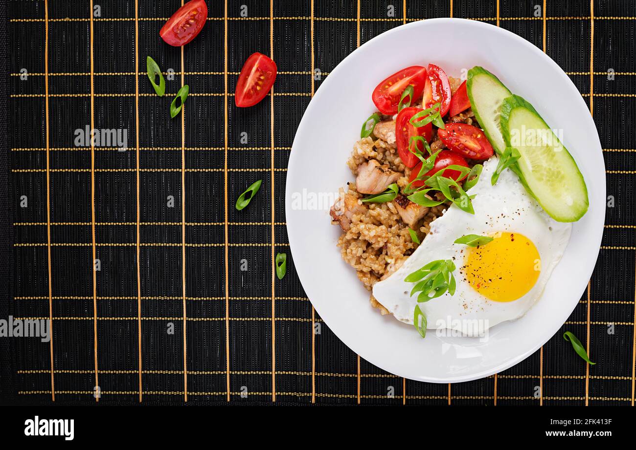 Nasi Goreng. Indonesian chicken fried rice on dark background. Nasi ...