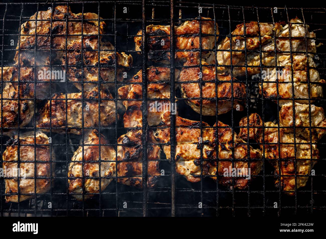 Meat is fried on the grill. The wire rack with roasted pork Stock Photo ...