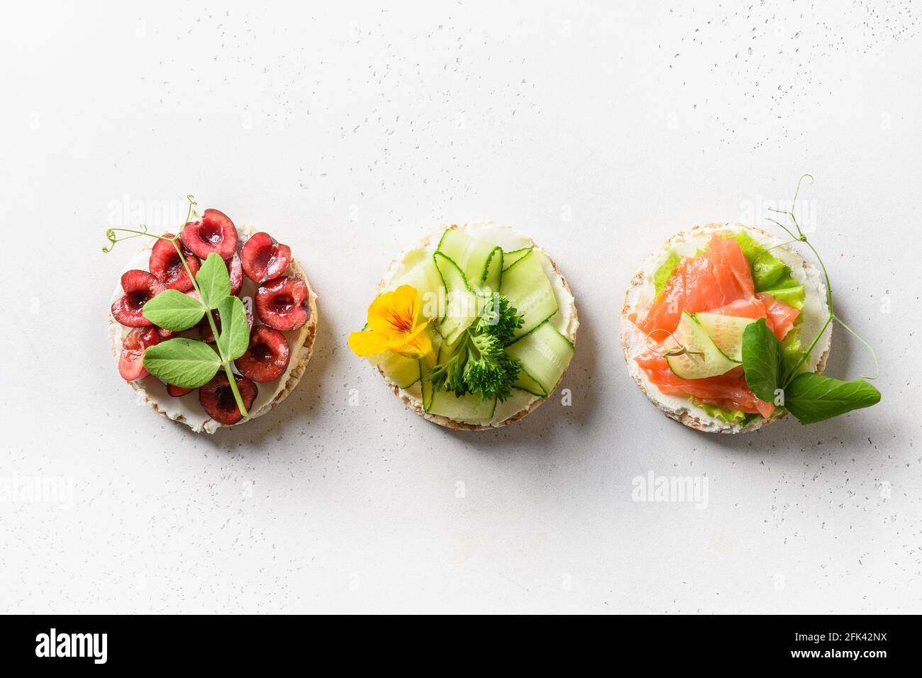 Rice crispbread with different toppings of vegetables, berries and red ...