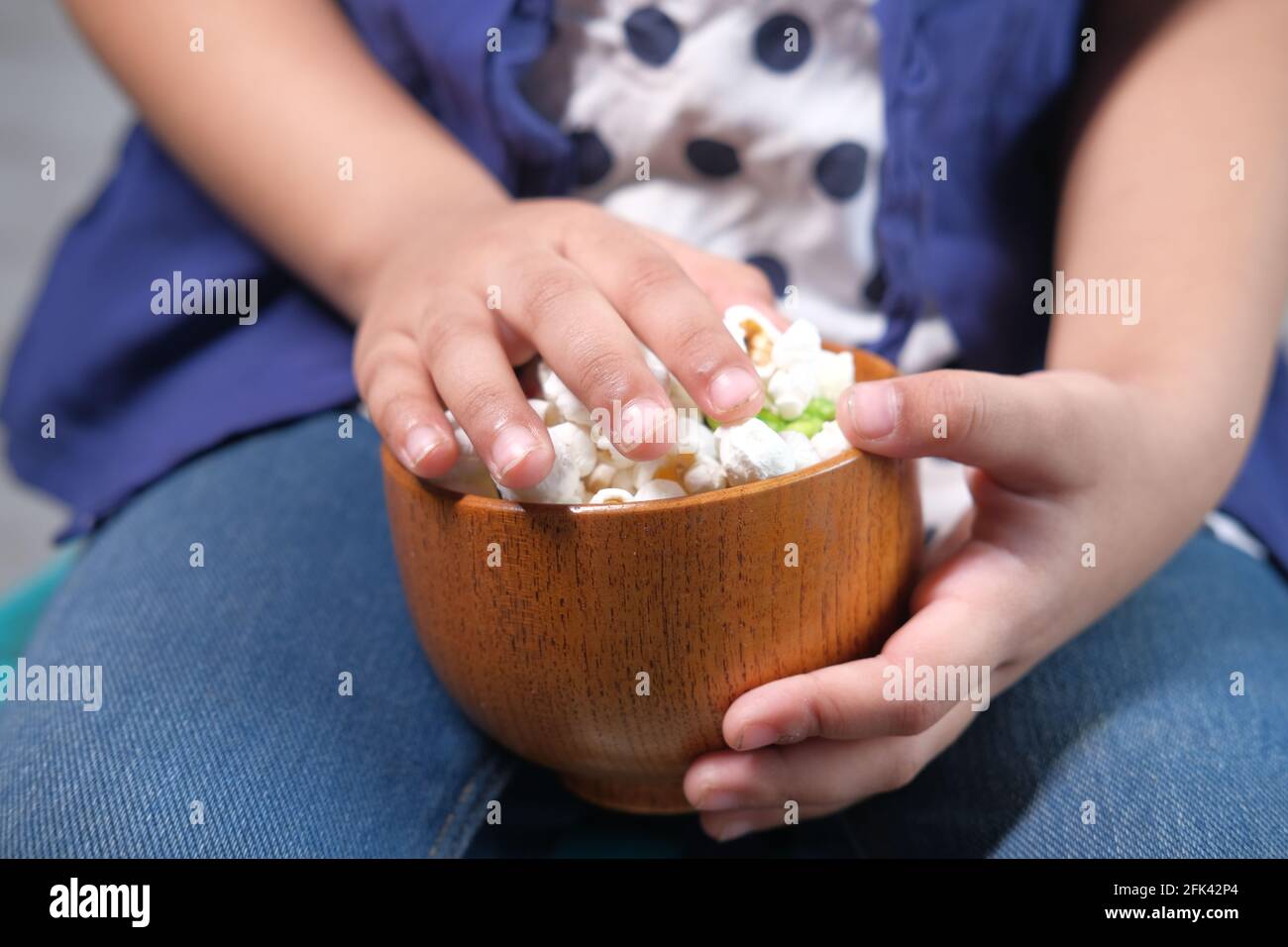 child girl hand holding a bowl of colorful popcorn Stock Photo - Alamy