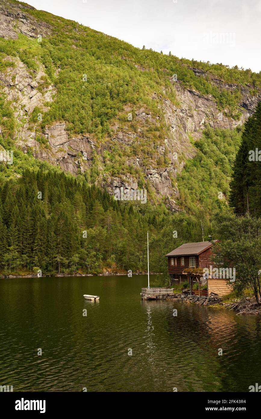 Beautiful mountainous landscape with greenery, lake and cabins in ...
