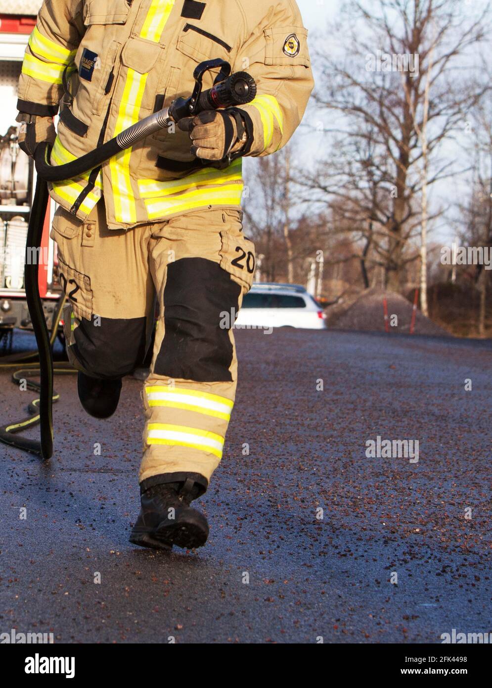 Fire-fighters on site at a fire scene Stock Photo - Alamy