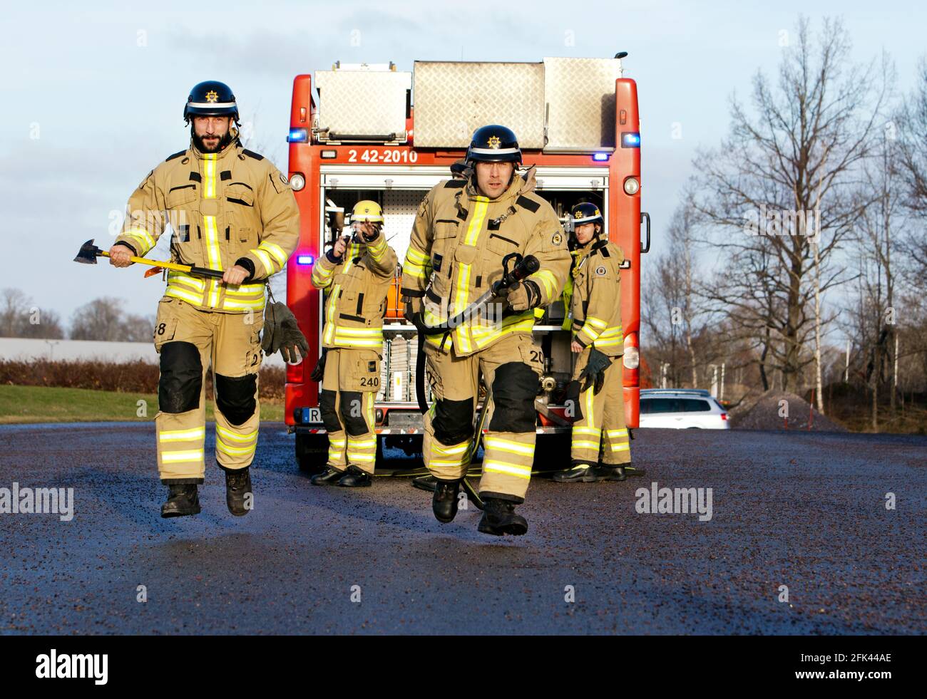 Fire-fighters on site at a fire scene Stock Photo - Alamy