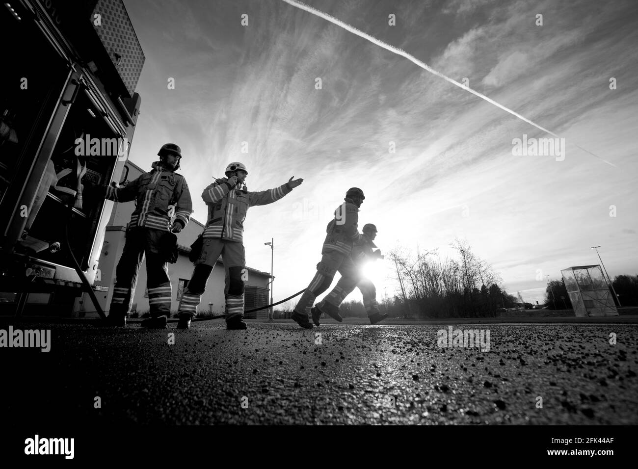 Fire-fighters on site at a fire scene Stock Photo - Alamy