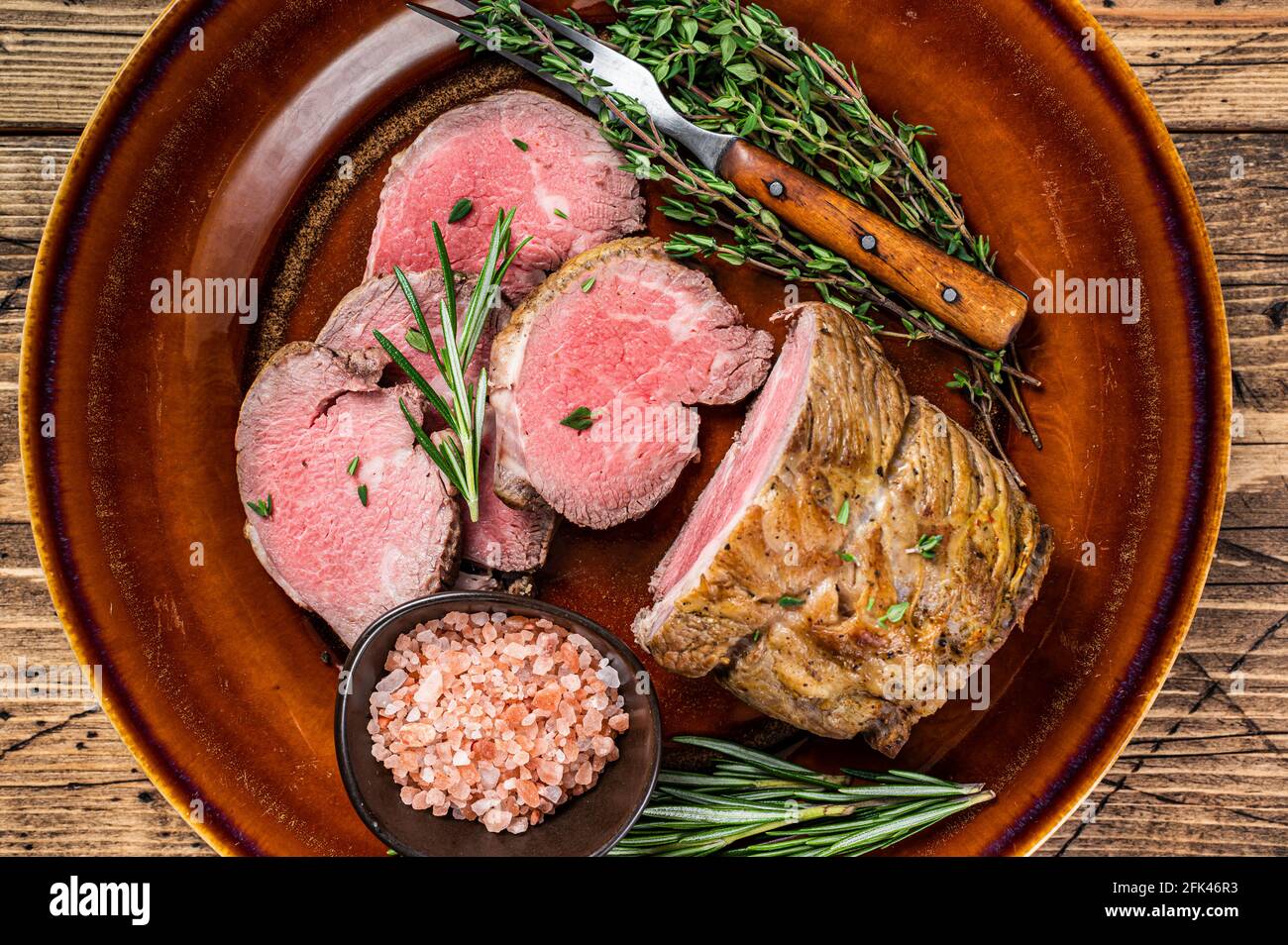 Grilled Roast beef fillet meat on a rustic plate with salt. background ...