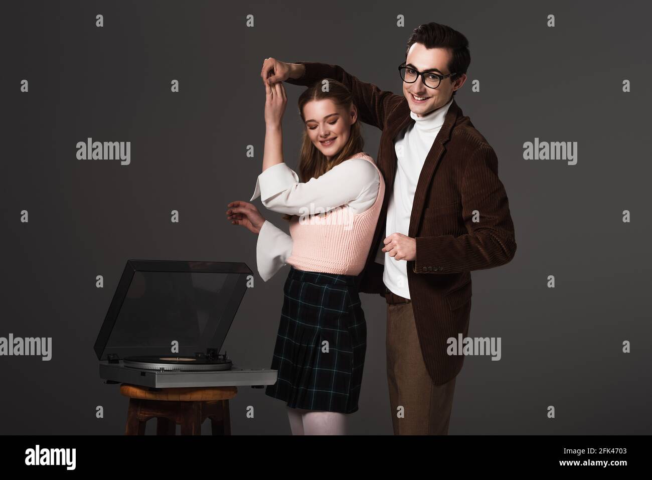 happy, old fashioned couple dancing near record player isolated on ...