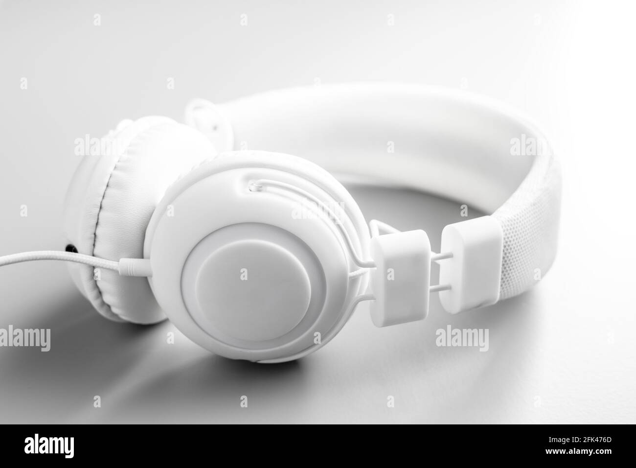 White wired stereo headphones on gray background Stock Photo - Alamy