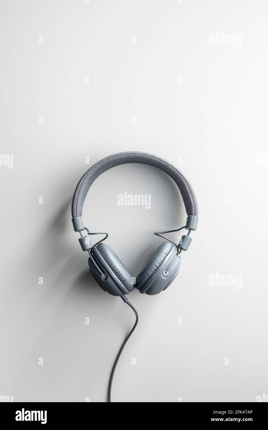 Gray wired stereo headphones on gray background. Top view Stock Photo ...