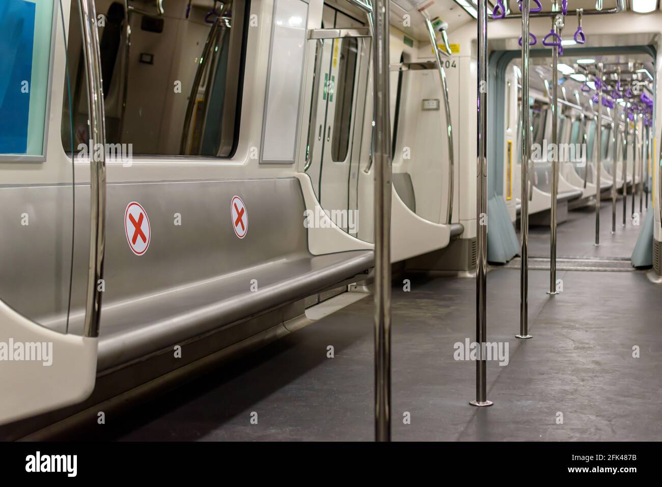 Interior of an empty seats of metro rail carriage with red cross mark ...