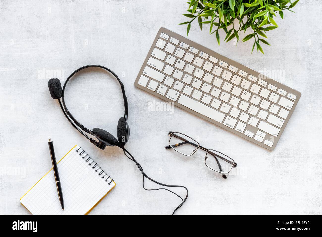 Office desk with headset and pc call center support Stock Photo - Alamy