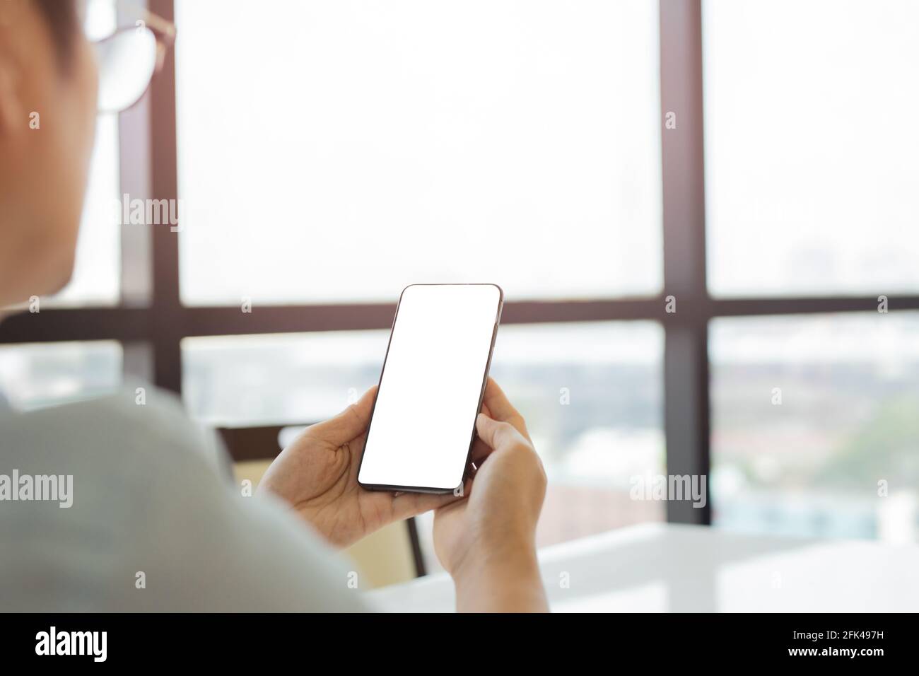 Man hands using smart phone with blank white screen Stock Photo - Alamy