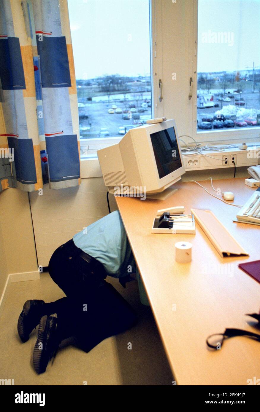 A police officer, at a police station, who has computer problems Stock ...