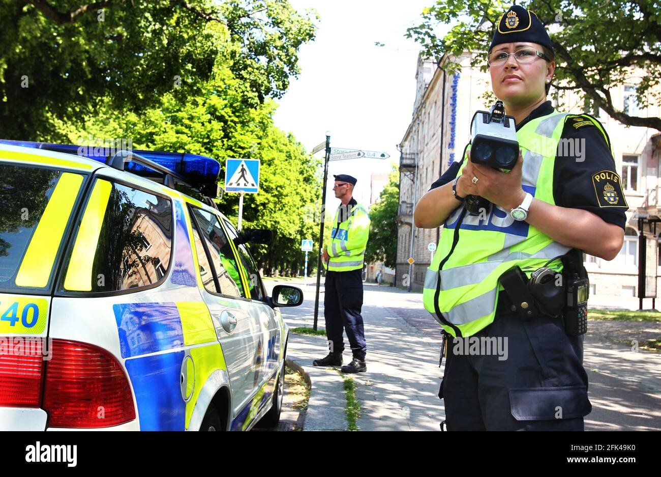 Traffic police with laser along a road in a city Stock Photo - Alamy