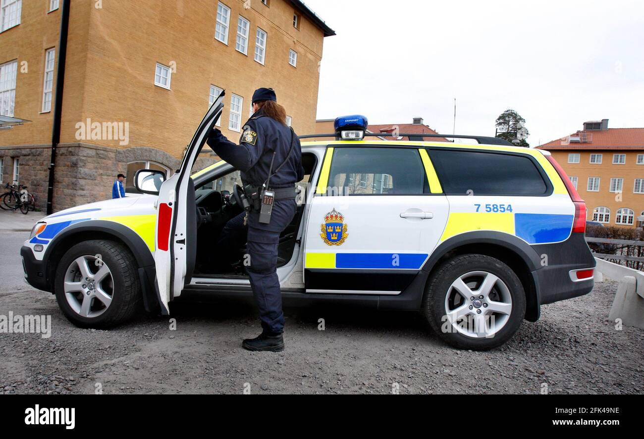 Female police officer at a police car, Linköping police station, Sweden ...
