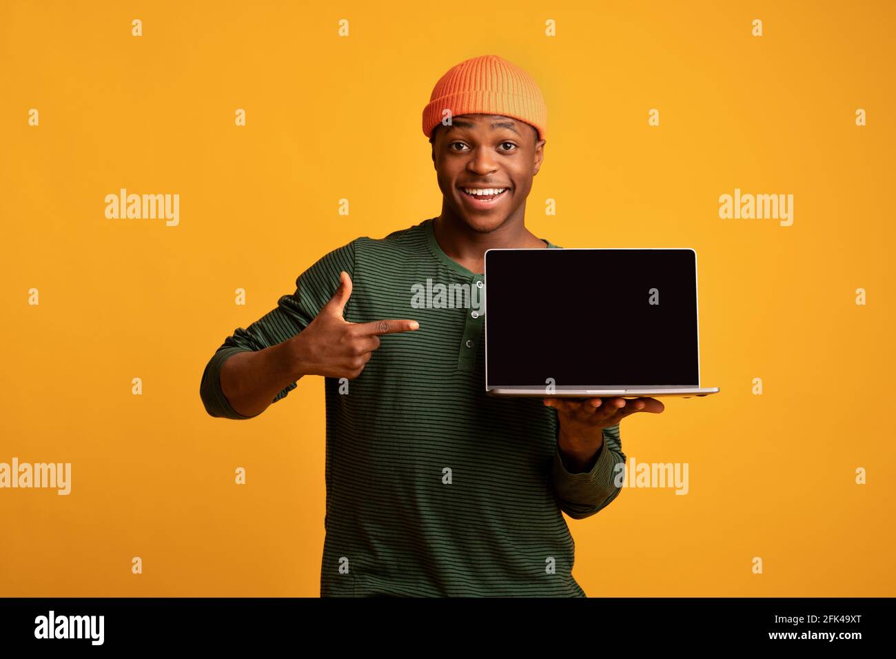 Cool Website. Cheerful African Guy Pointing At Laptop Computer With ...