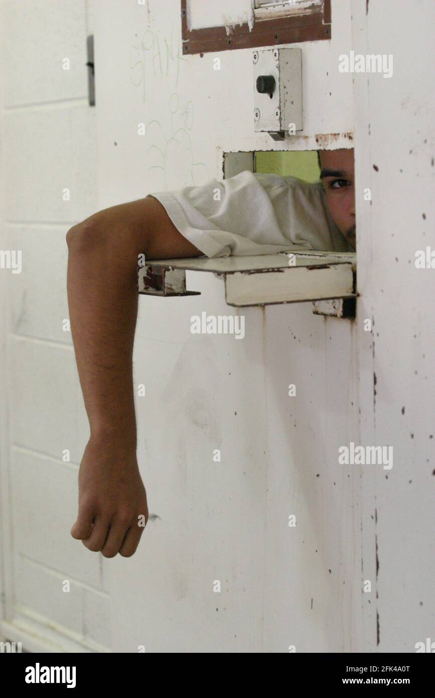 STOCKTON, UNITED STATES - Jul 05, 2005: Prisoner peeking out of cell ...