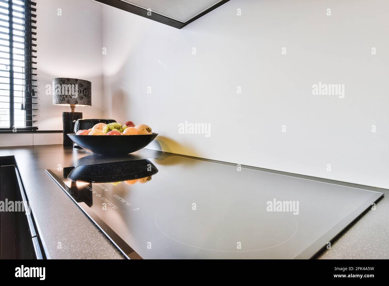 Kitchen counter with shiny built in hob Stock Photo - Alamy