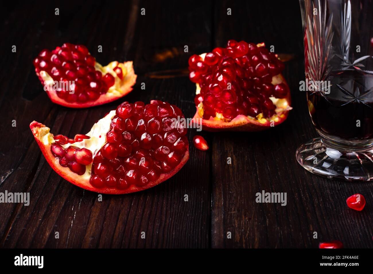 Broken pomegranate. Pomegranate seeds on the table. Vintage still life ...
