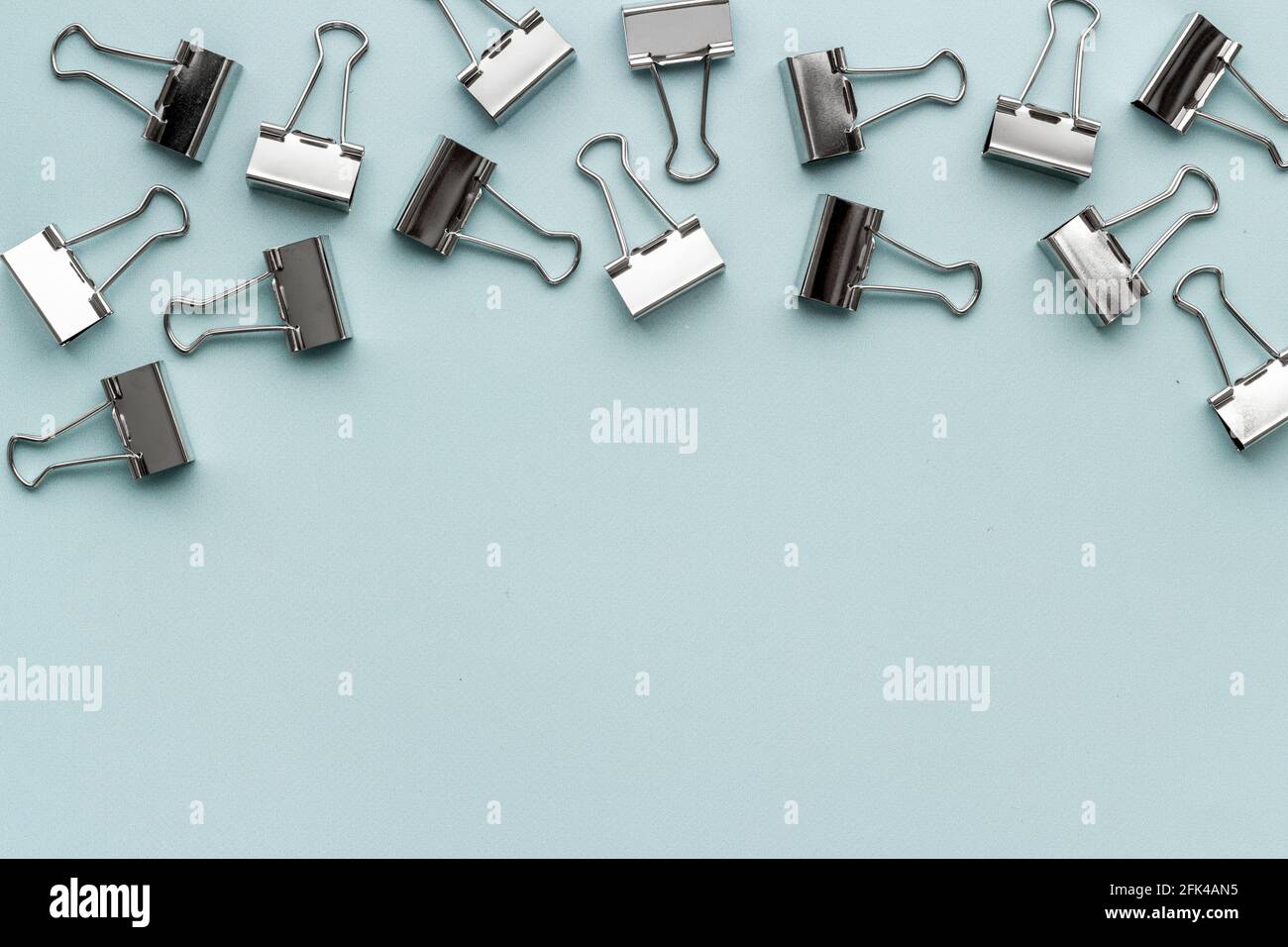 Office supplies background - paper binder clips top view Stock Photo ...