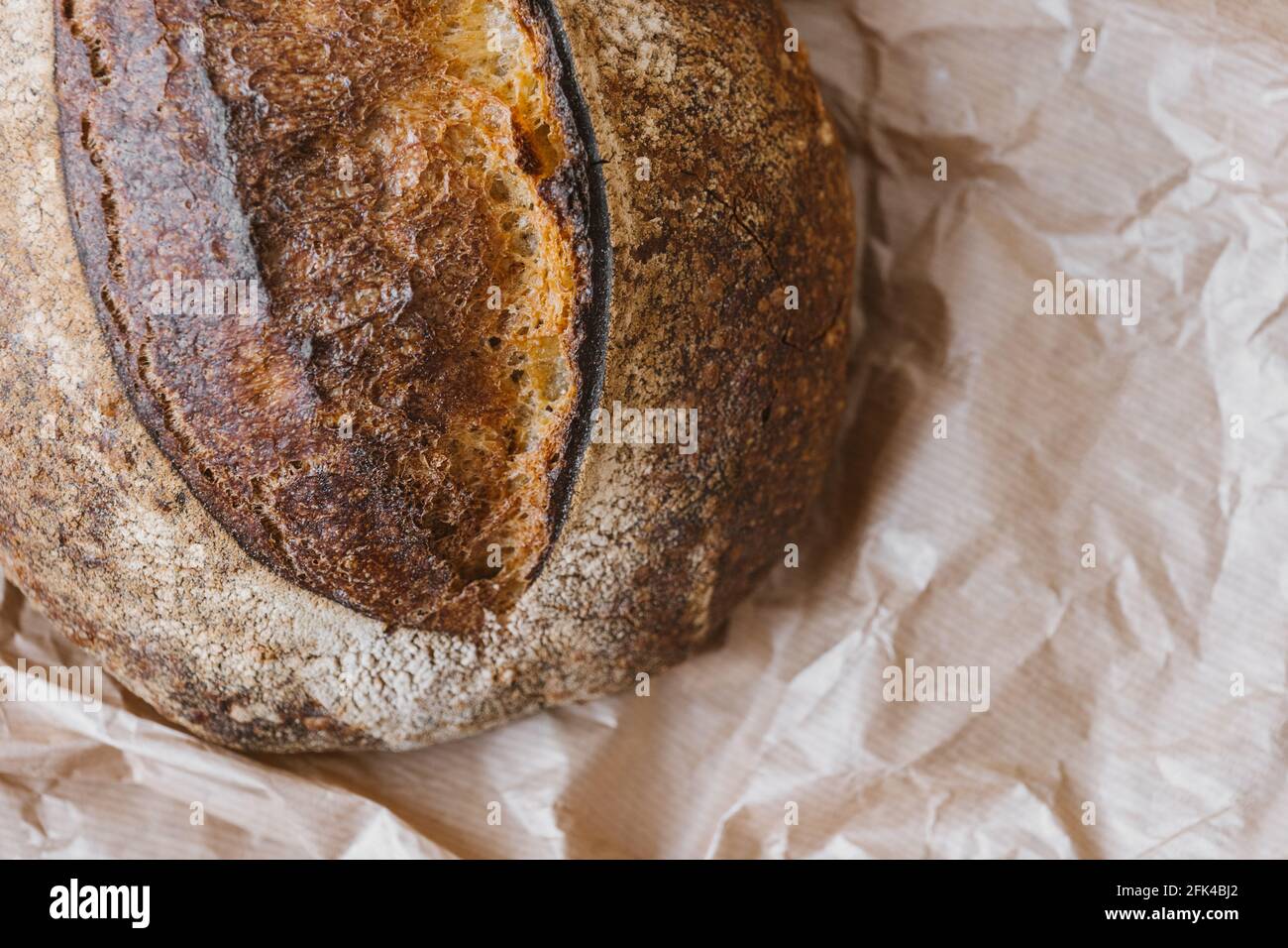Close-up of homemade wheat bread on craft paper. Top view of crispy ...