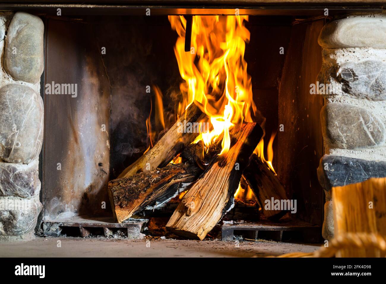 fire in a rustic fireplace in a traditional mountain hut Stock Photo ...